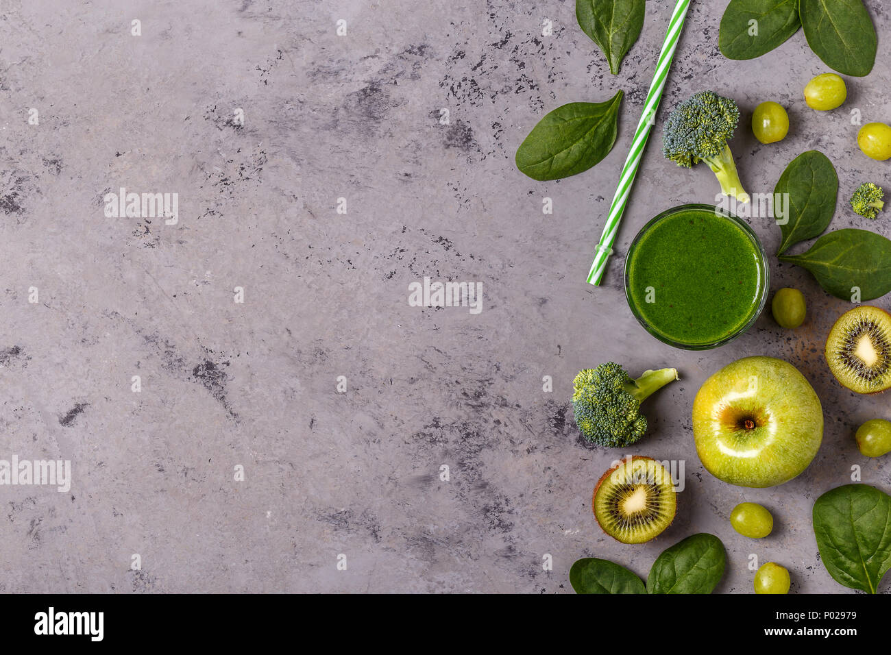 Green smoothie with ingredients on concrete surface, top view, copy ...