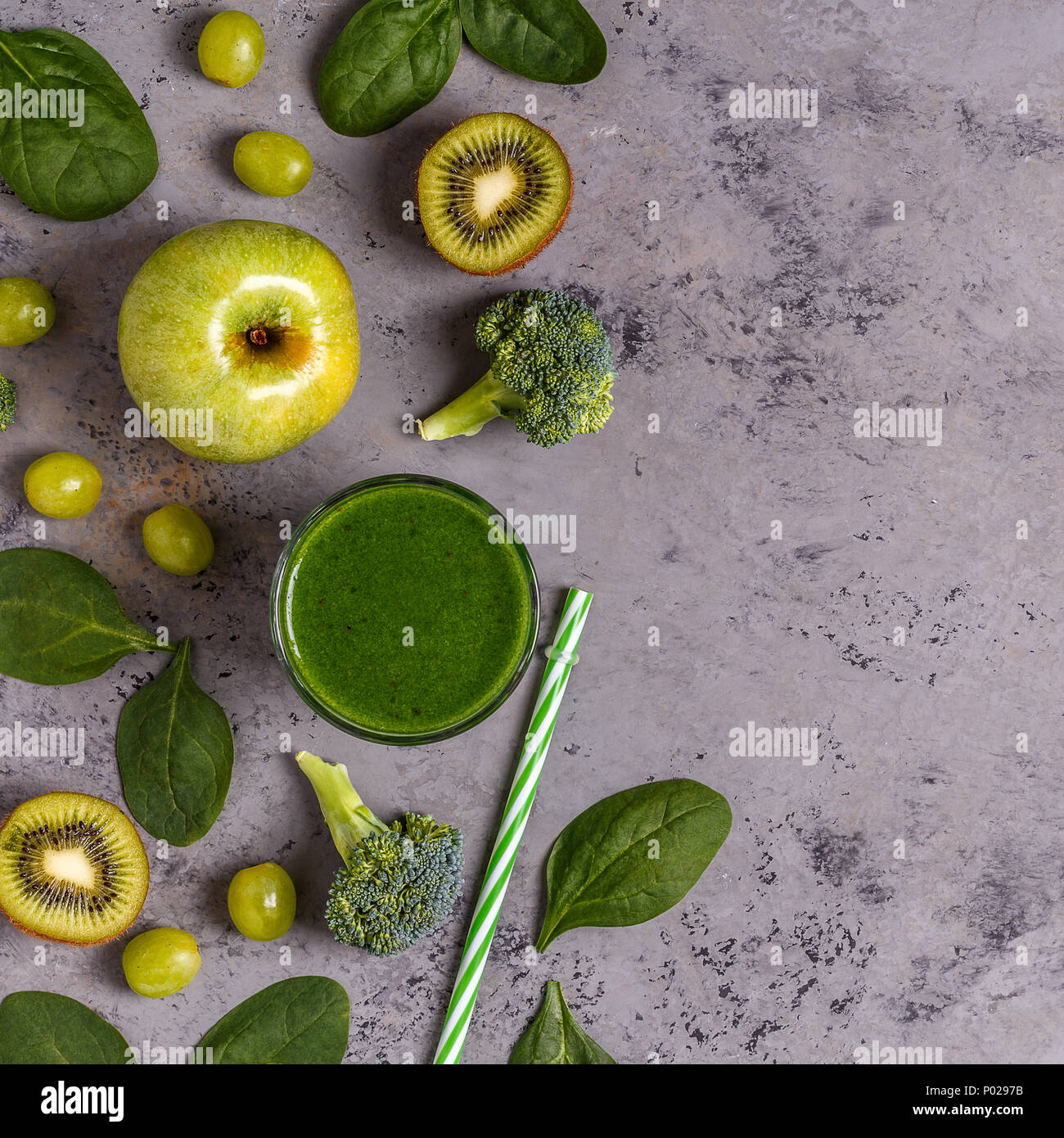 Green smoothie with ingredients on concrete surface, top view, copy ...