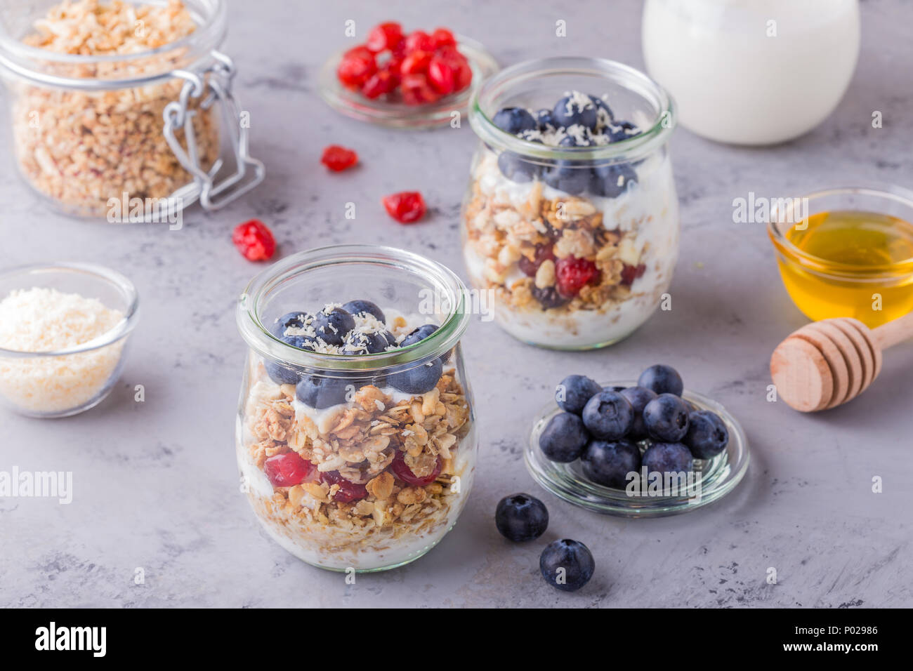 Healthy breakfast - glass jars of oat flakes with fresh fruit, yogurt ...