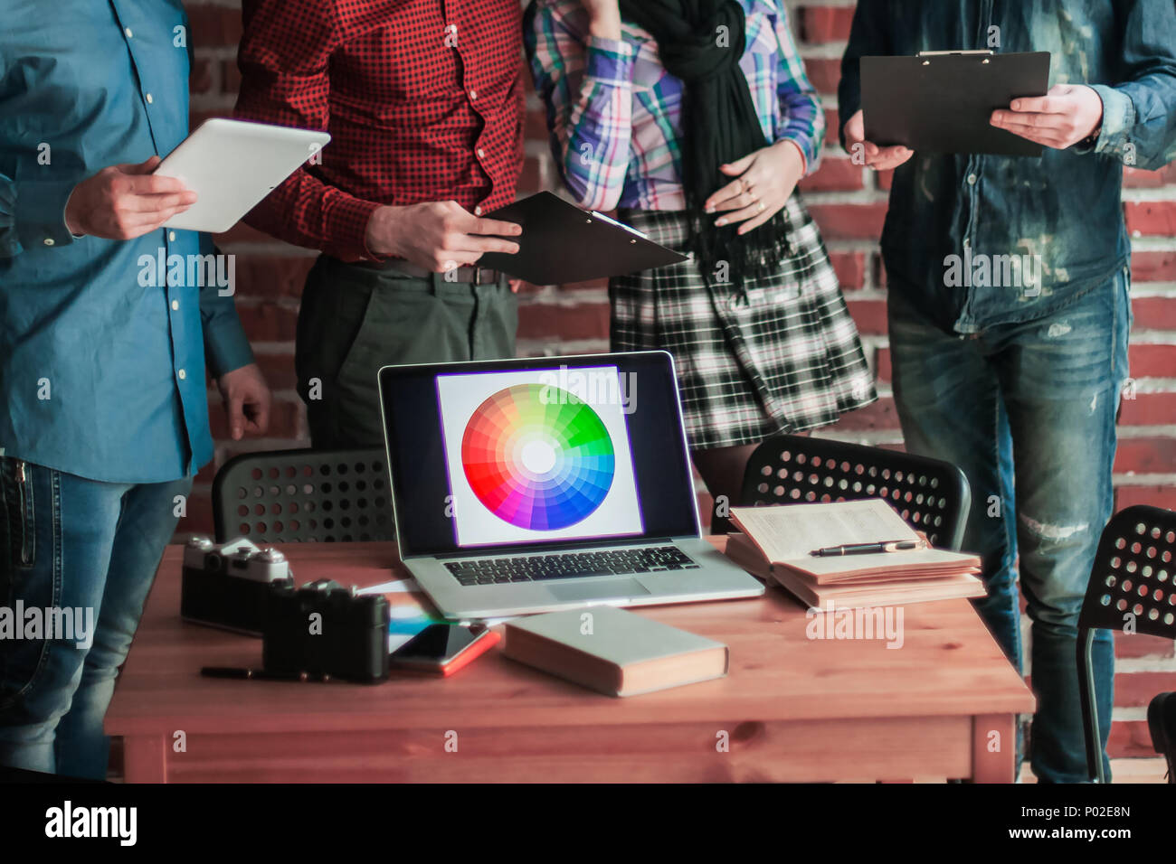 open laptop computer with a color palette in workplace designer Stock ...