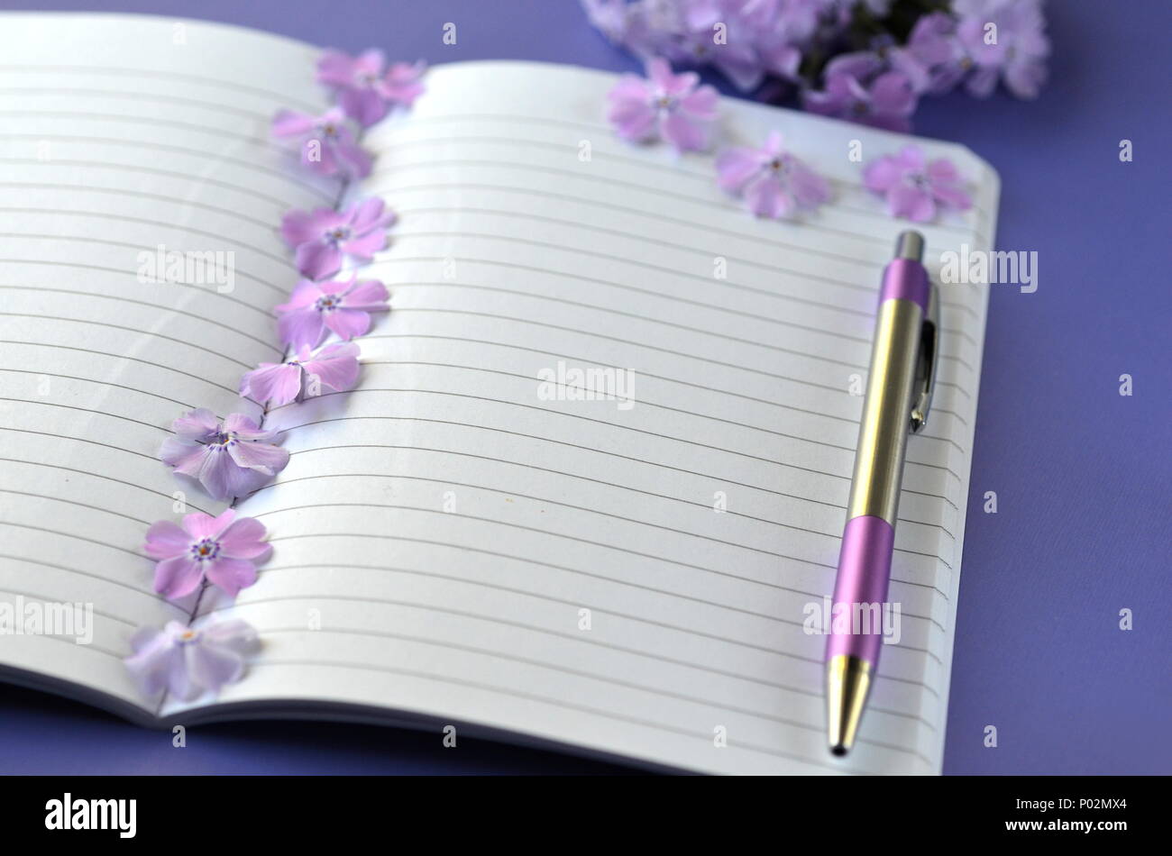 Ultra violet flatlay of feminine stationery, notebook, pen, lavender ...