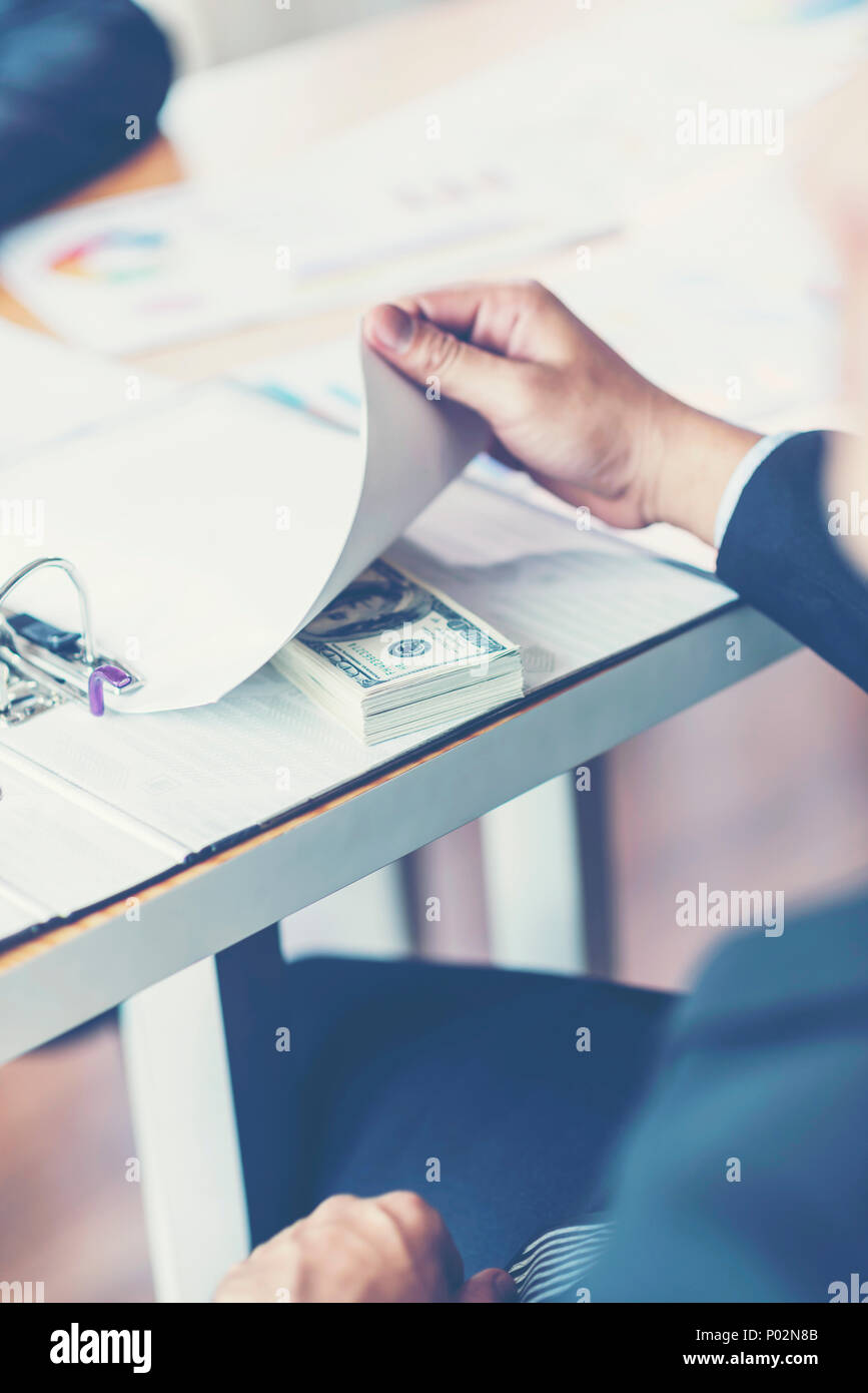 Bribery and corruption concept, bribe in the form of dollar bills ...