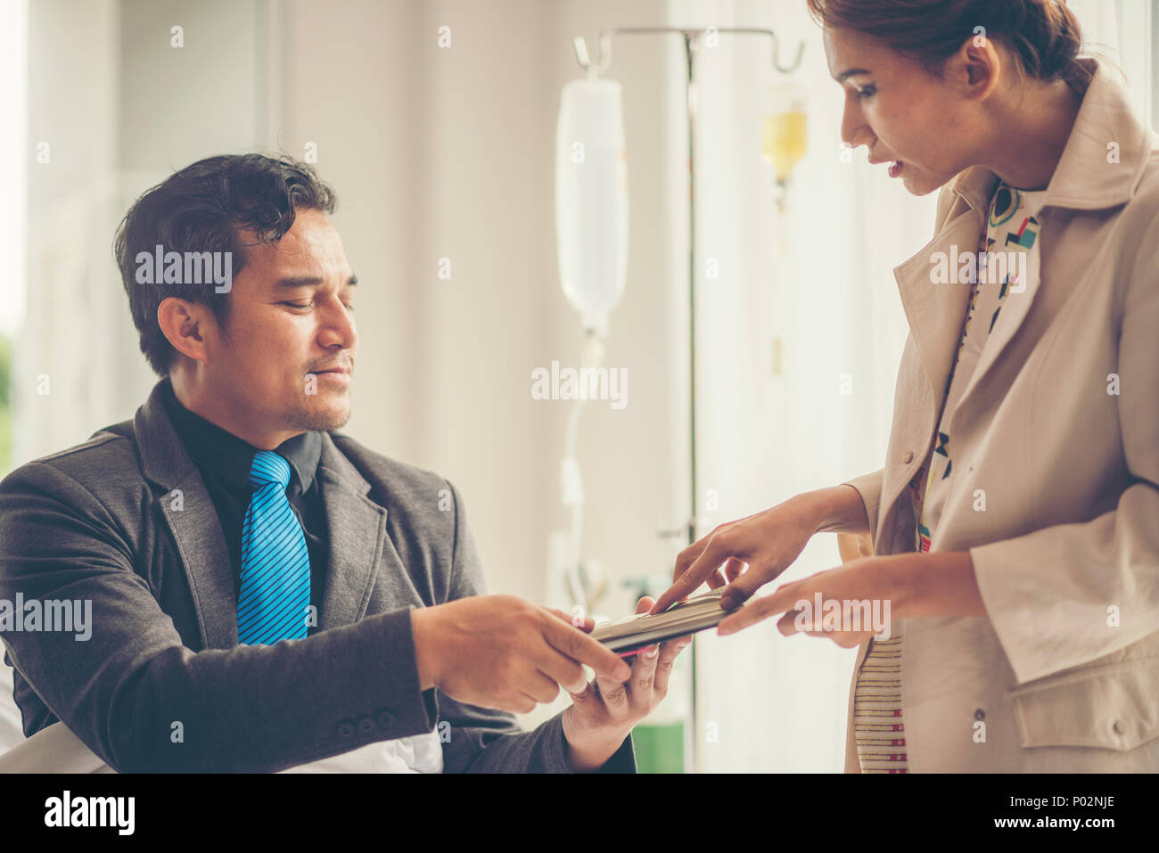 Sick Businessman are working on Hospital Bed with secretary women, Work ...