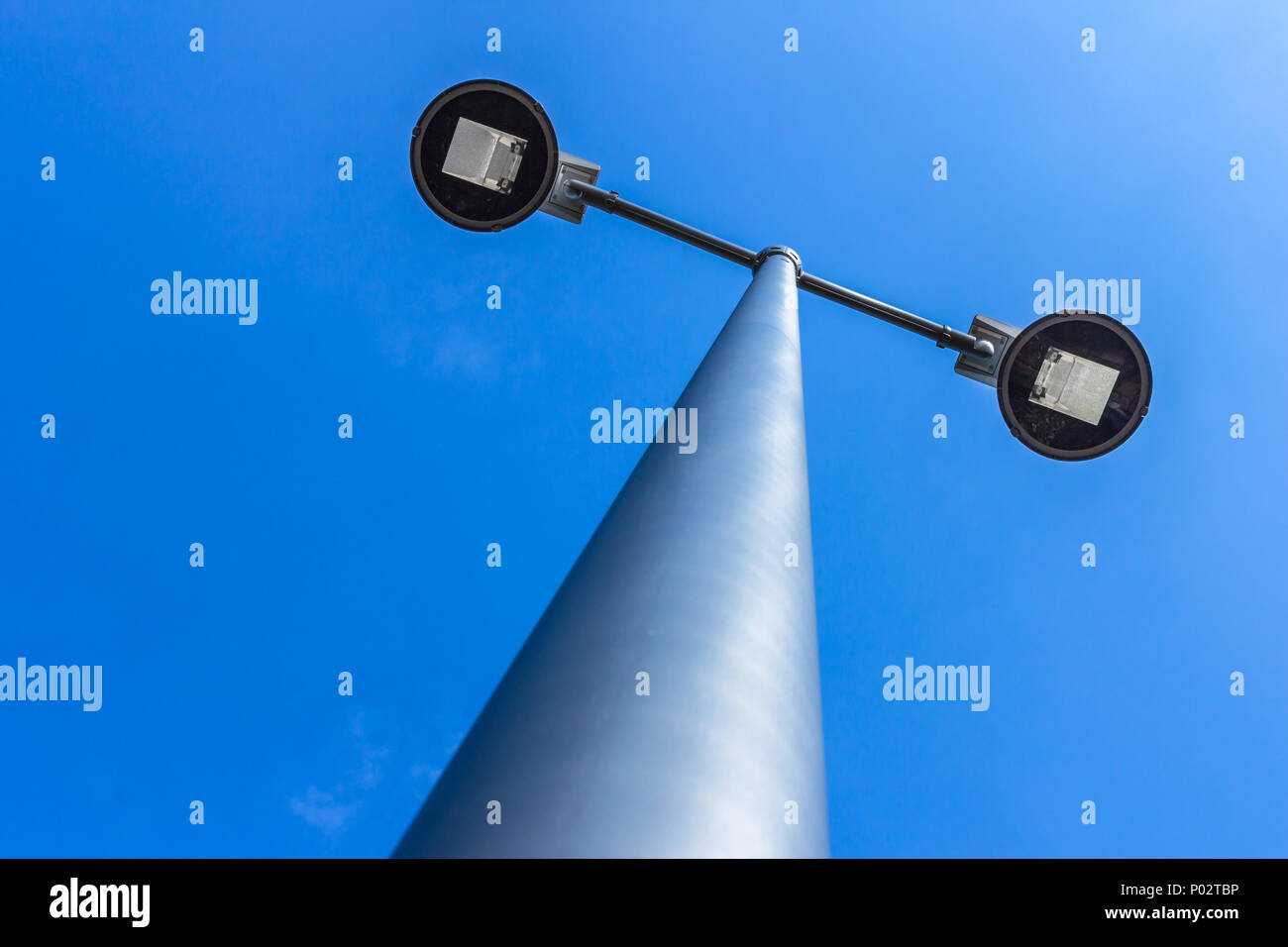 Double modern street light lamp on a blue sky background. Bottom view ...
