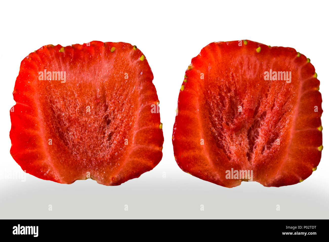 Macro photograph of two halves of a big ripe strawberry.Isolated image ...