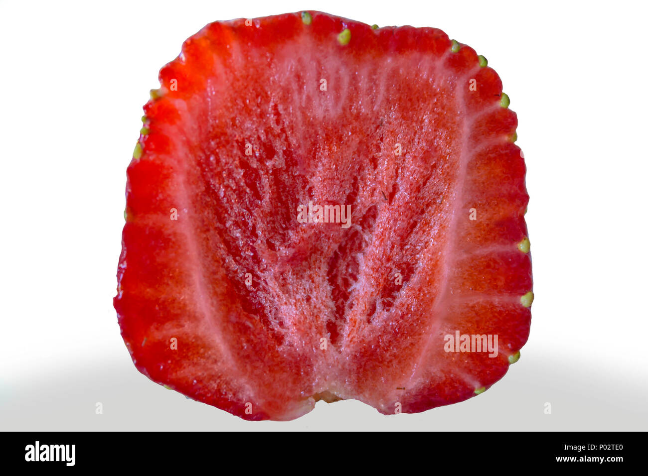 Macro photograph of a half of a big ripe strawberry. Isolated image on ...