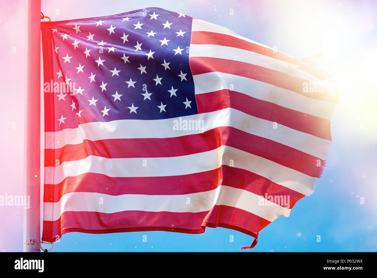 the American flag is flying in a strong wind Stock Photo - Alamy
