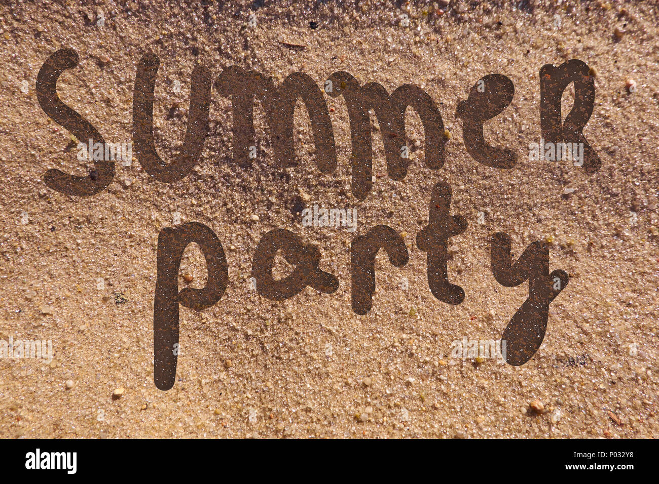 Summer party text hand drawn on a beach sand Stock Photo - Alamy