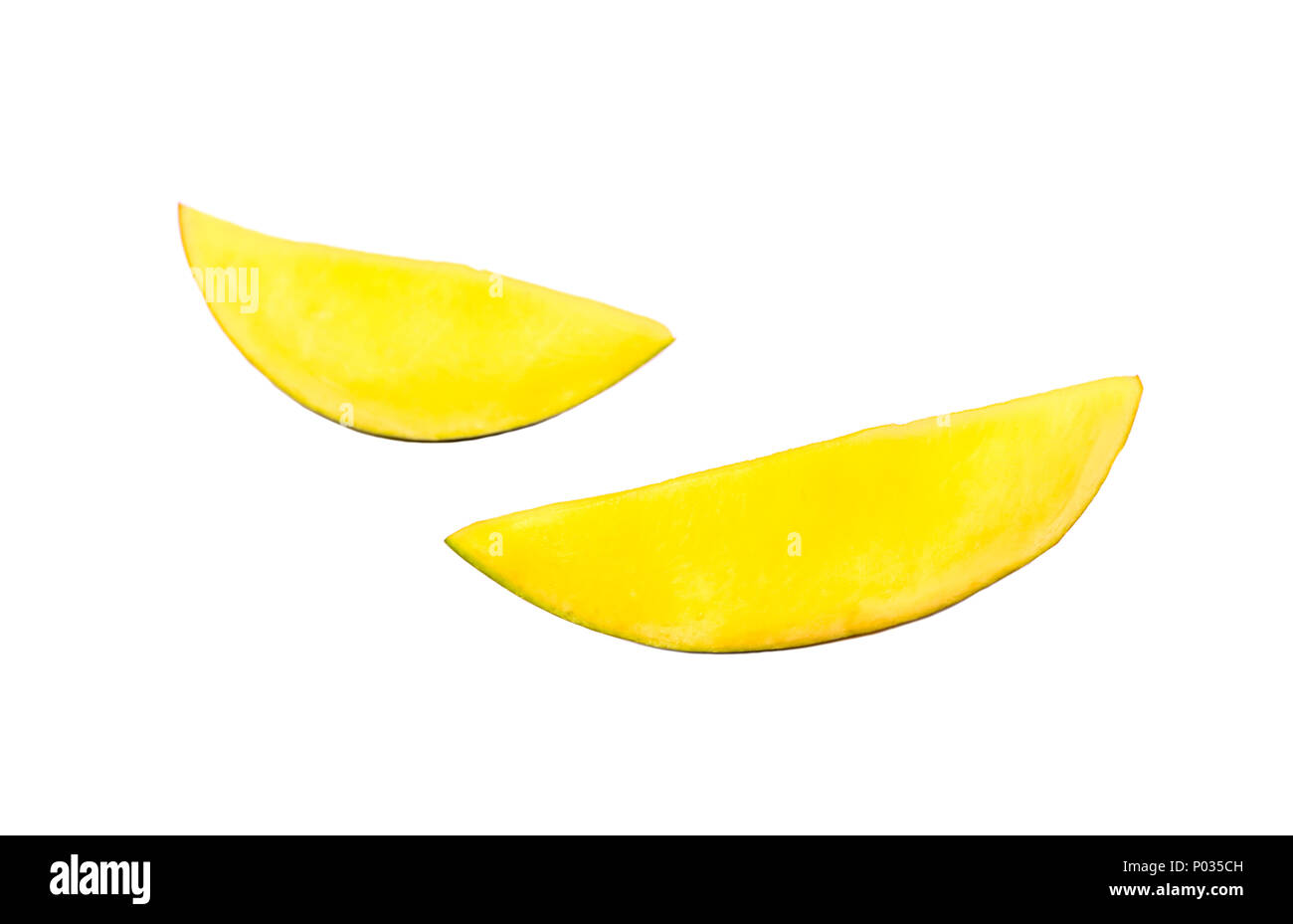 Two slices of fruit scattered mango on a white background Stock Photo ...