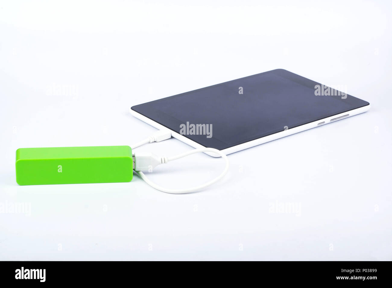White tablet charge through battery power bank Stock Photo - Alamy