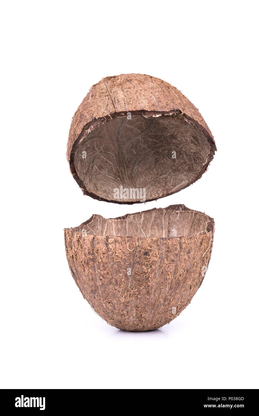 The two halves of the broken shell of coconut fruit in half on a white ...