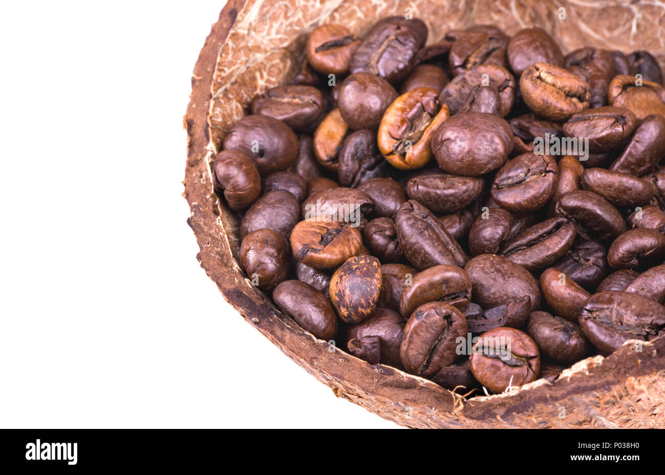 Roasted coffee beans in coconut shell close-up Stock Photo - Alamy