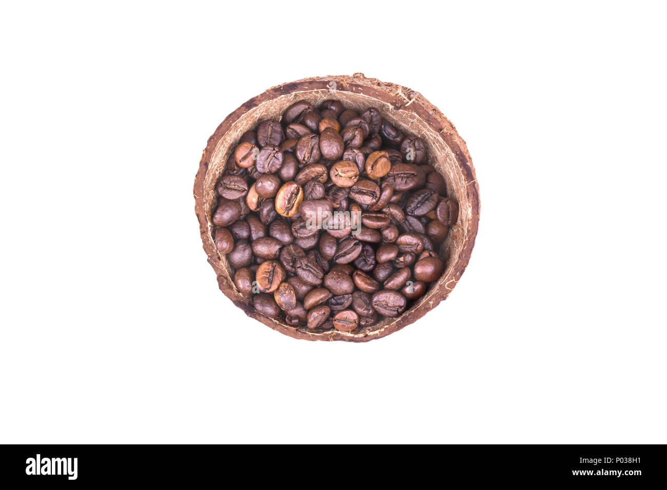 Roasted coffee beans in coconut shell on a white background Stock Photo ...