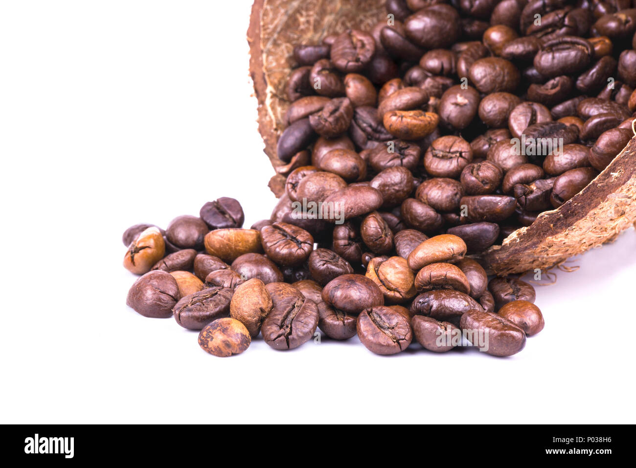 Scattered roasted coffee beans from coconut shell Stock Photo - Alamy