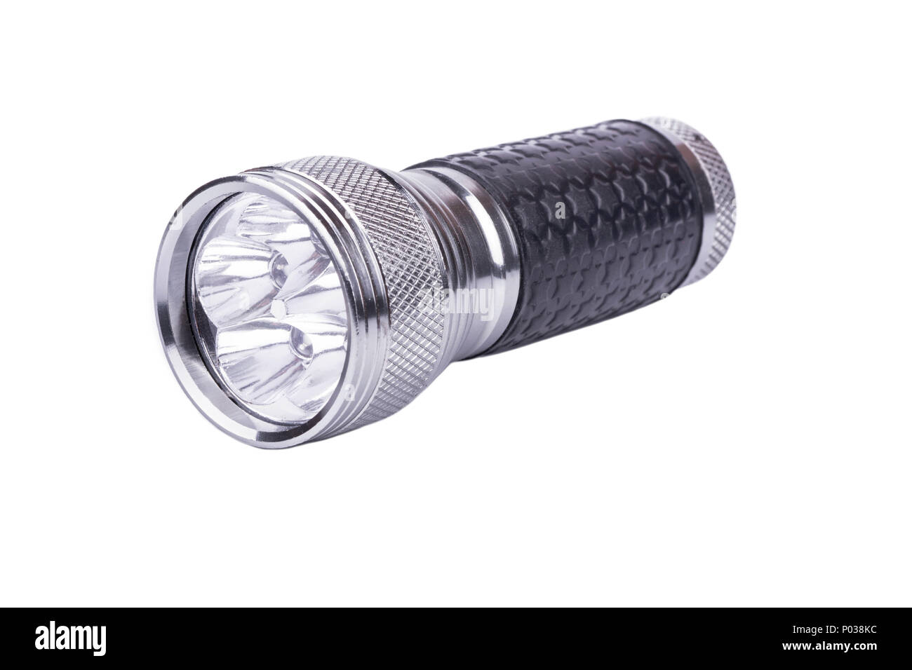 Handheld metal flashlight with rubber handle on a white background ...