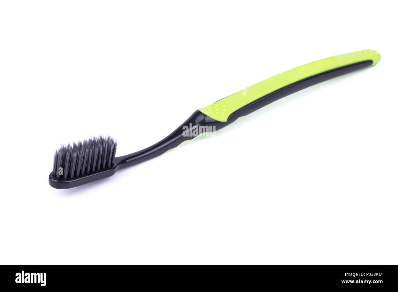 Toothbrush black and green color on a white background Stock Photo - Alamy