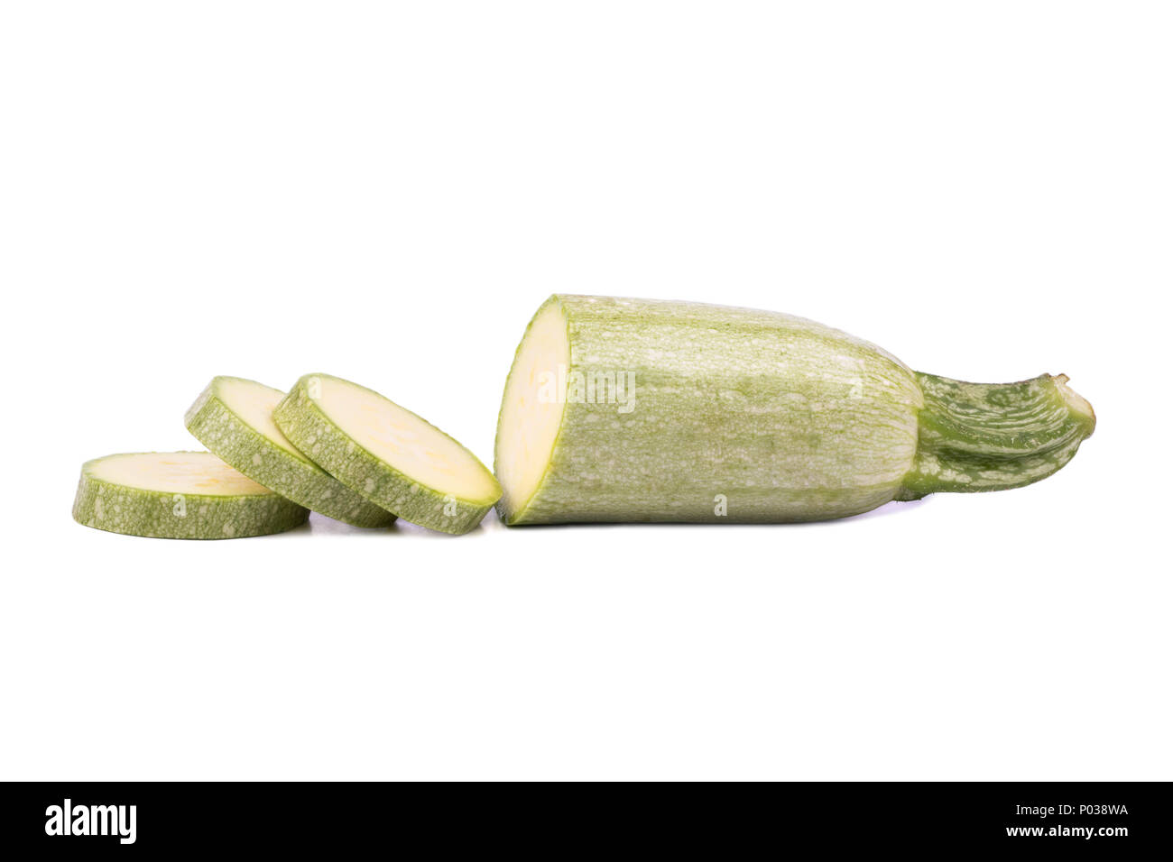 Half of green vegetable marrow with three slices on a white background ...