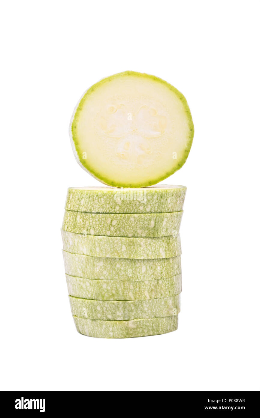 Cut a few slices of vegetable marrow stacked on a white background ...