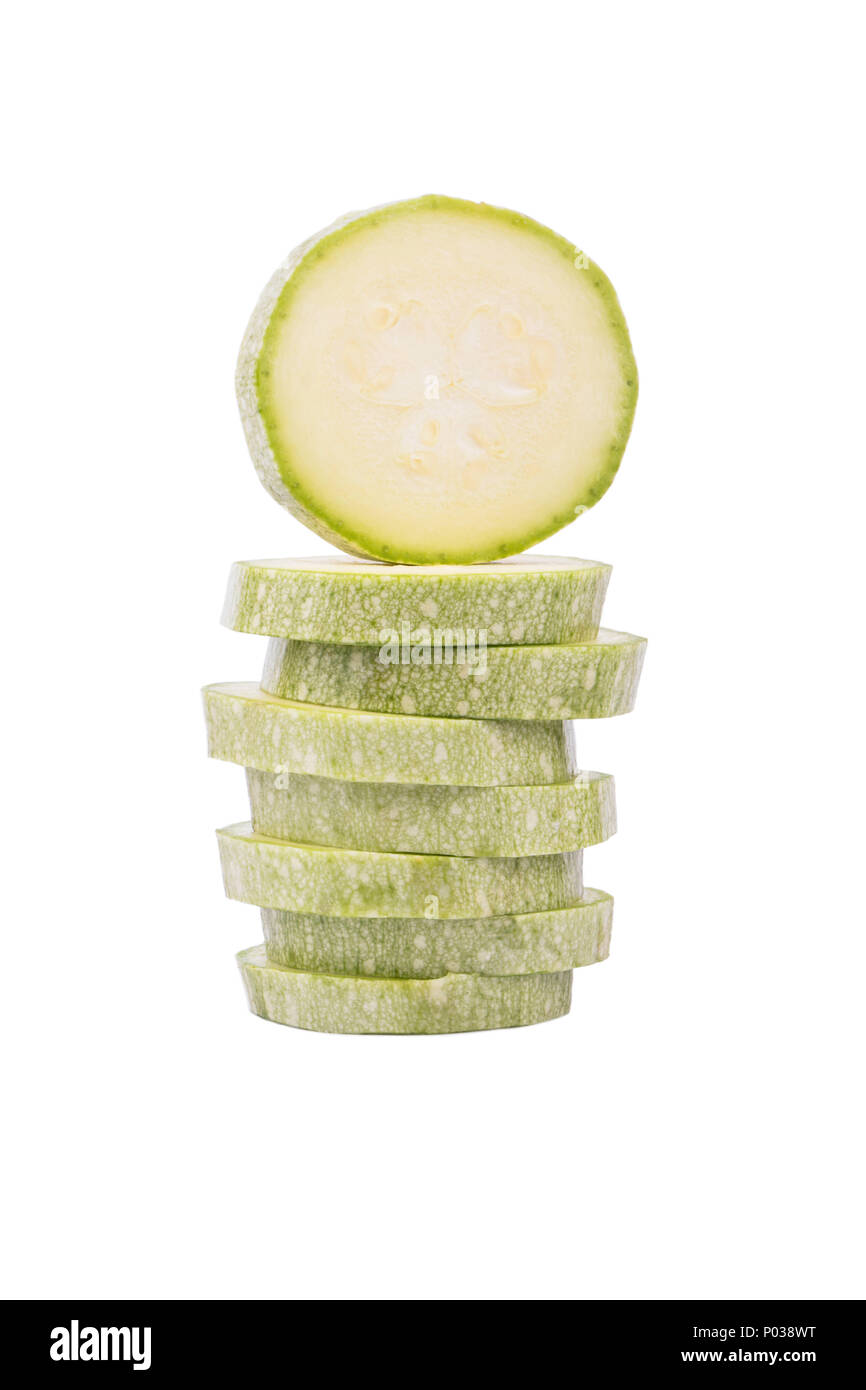 Cut a few slices of vegetable marrow stacked on a white background ...