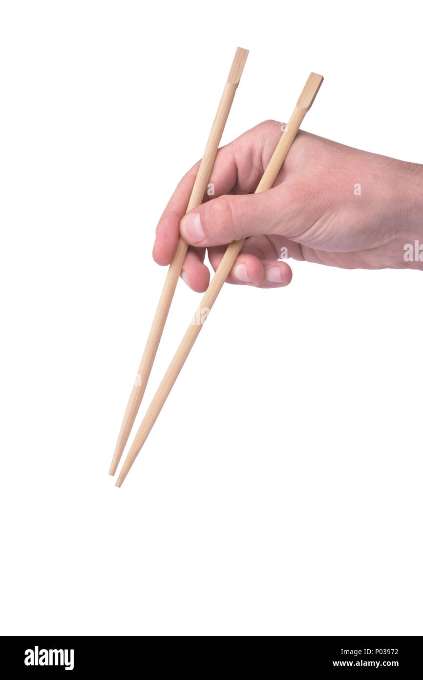 Man holds in his hand wooden chopsticks made of bamboo on a white ...
