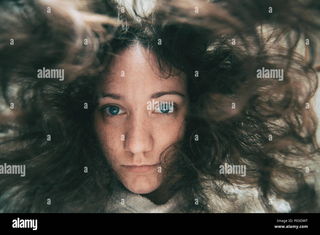 a girl looking at the camera face down Stock Photo - Alamy