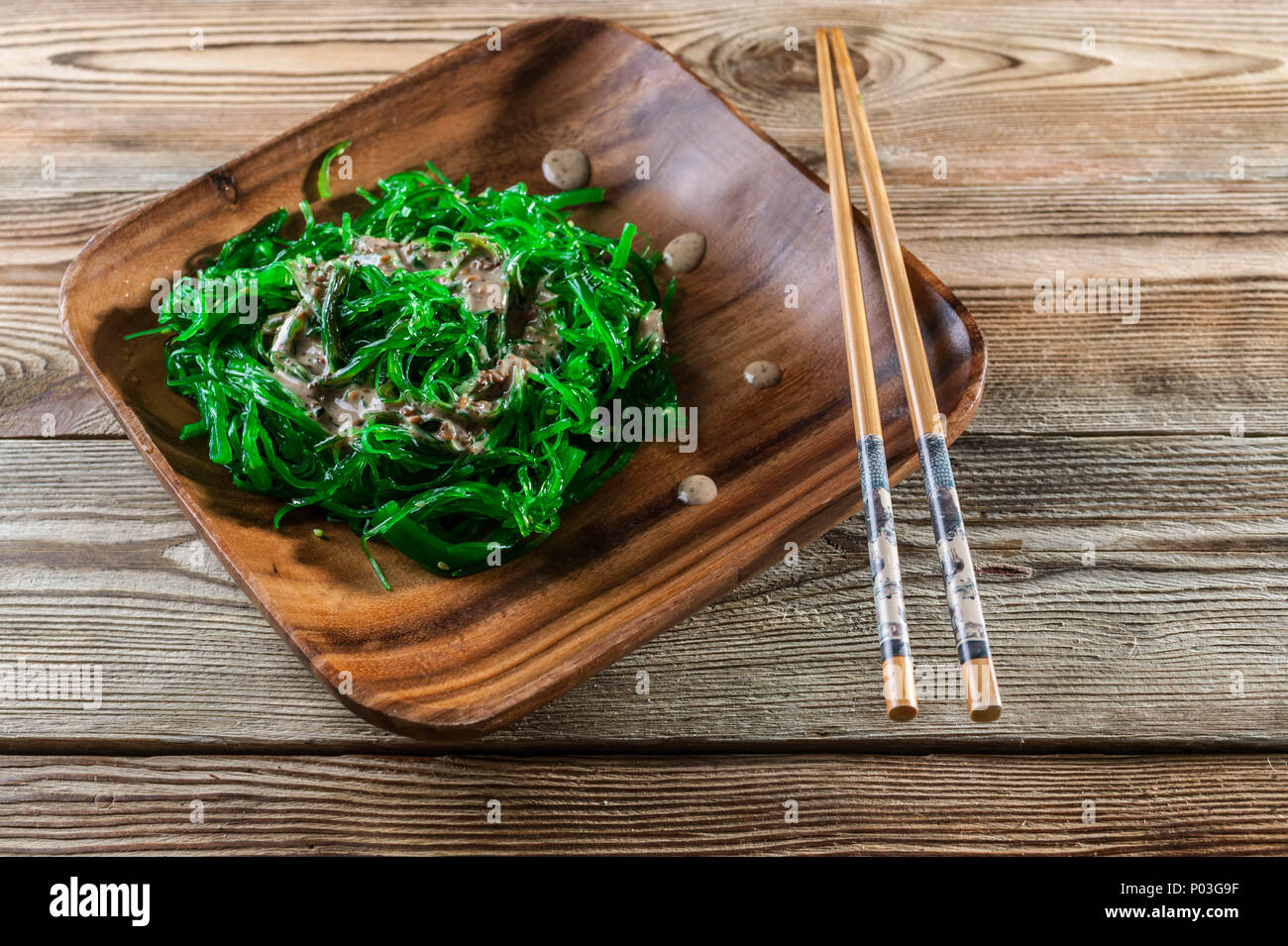 Chukka Salad with walnut sharp sauce in a wooden dish on a wooden ...
