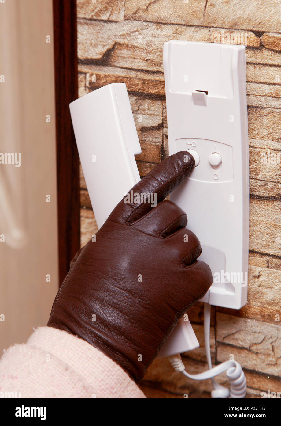 The female gloved hand presses the combination lock button to open the ...