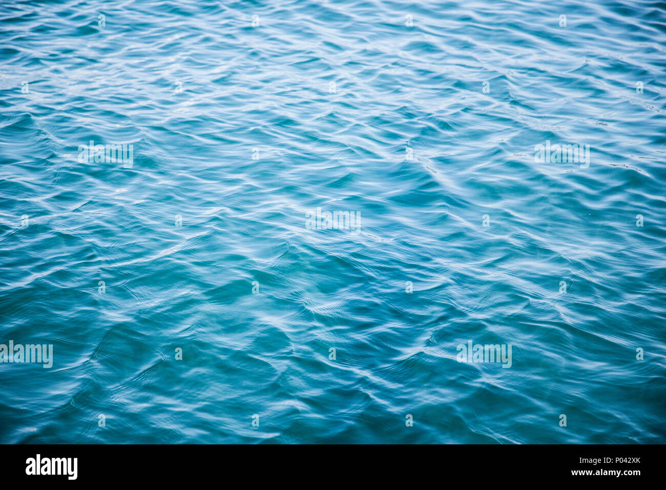 gentle waves on vivid blue ocean surface Stock Photo - Alamy