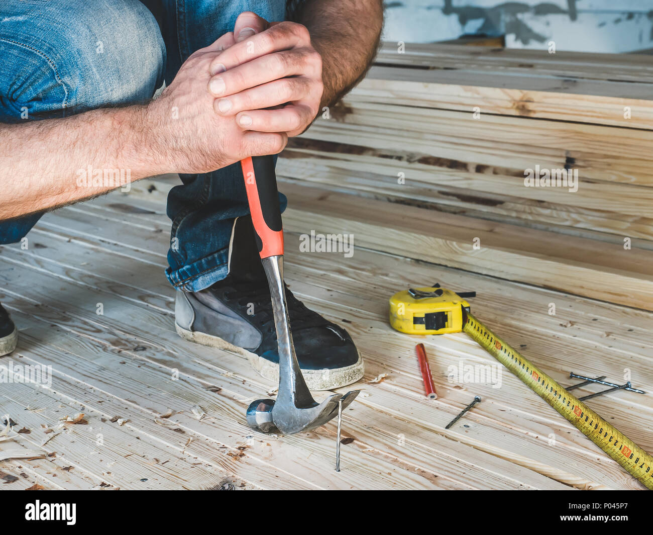 Strong men's hands and tools for working with wood inside the house ...