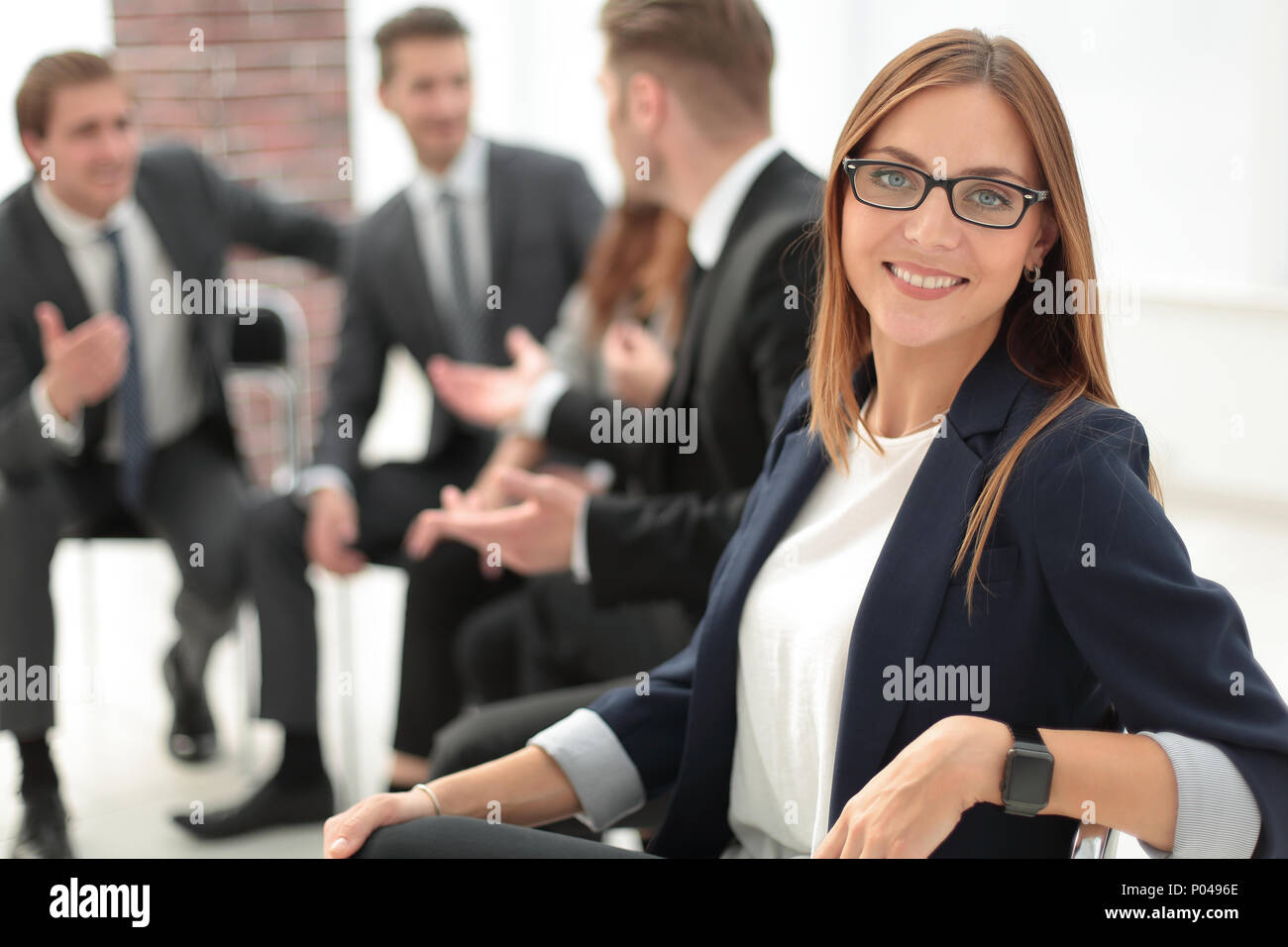 Attractive office worker standing Stock Photo - Alamy