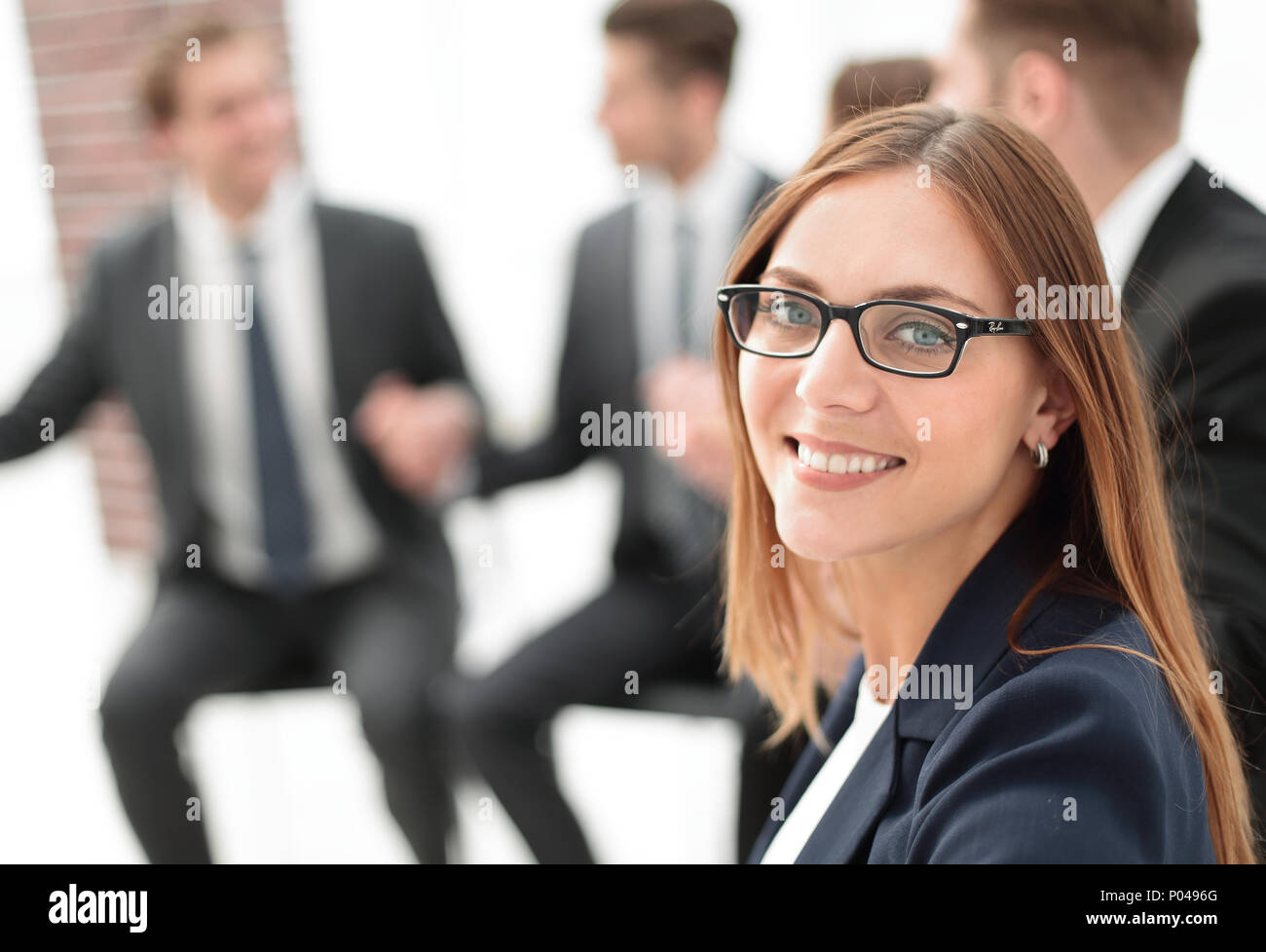 Attractive office worker standing Stock Photo - Alamy