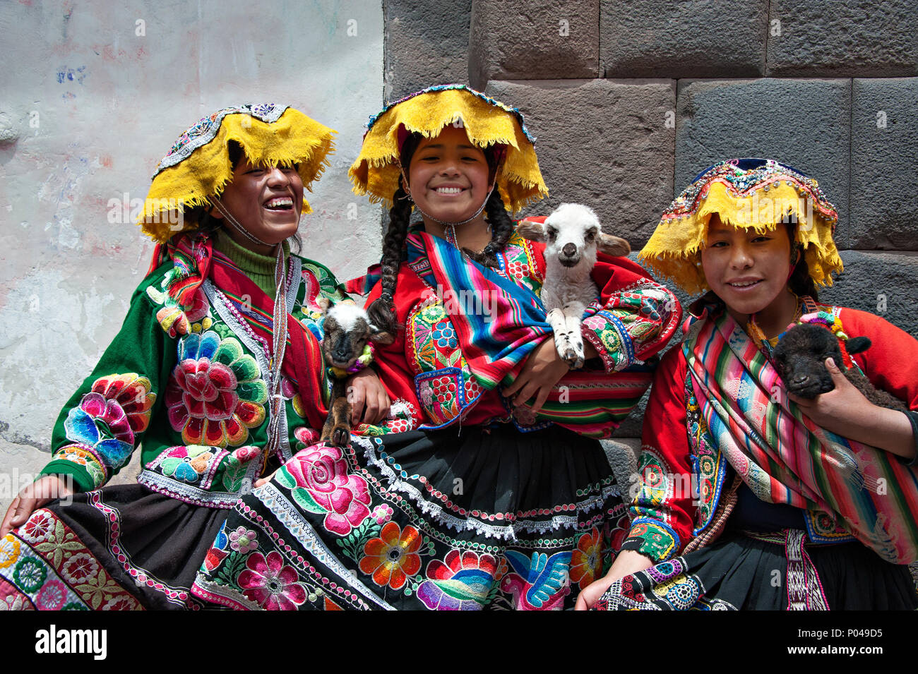 Peru ladies in traditional dress posing for photographs in the ancient ...
