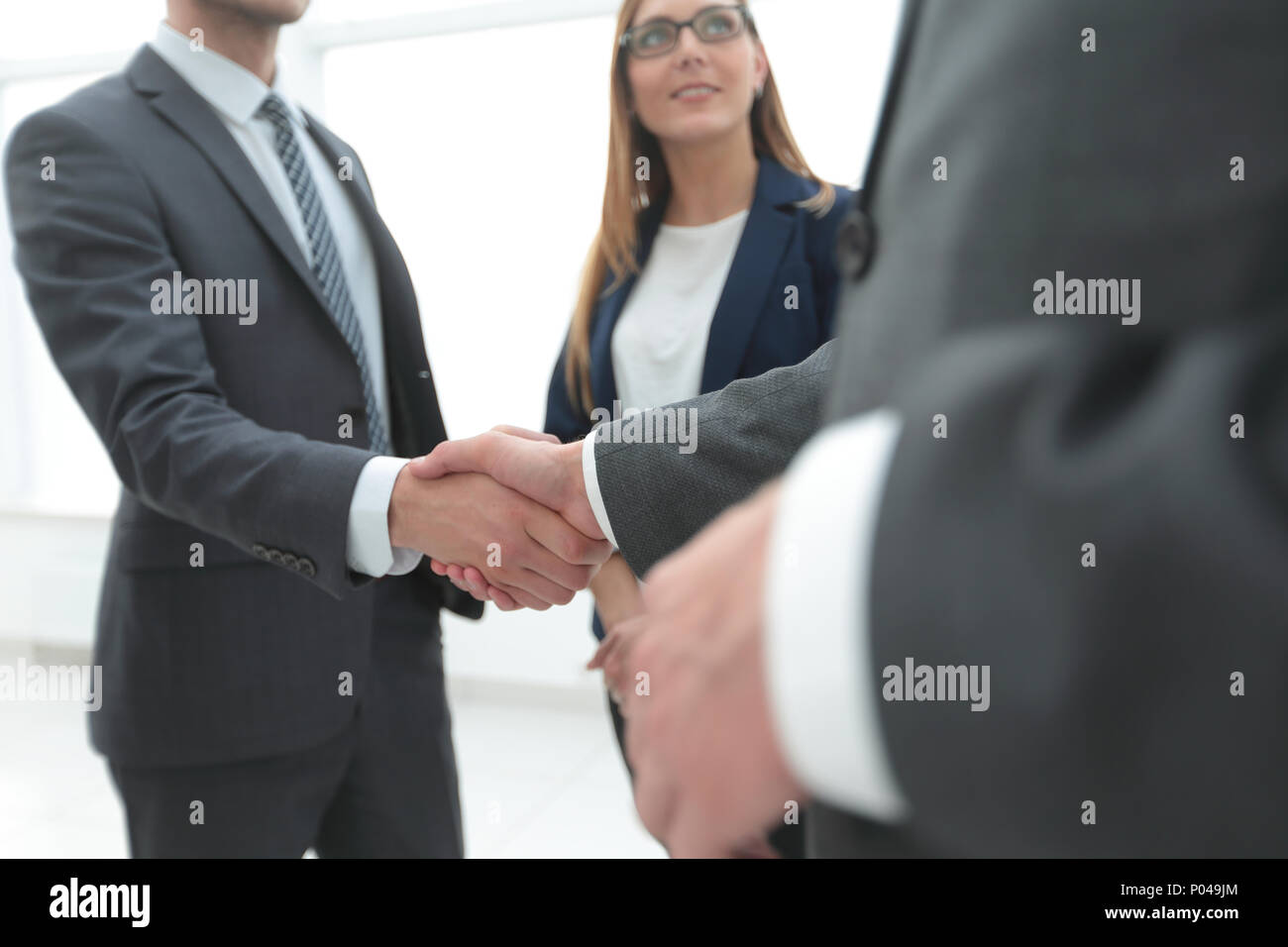 Business shaking hands in the office Stock Photo - Alamy