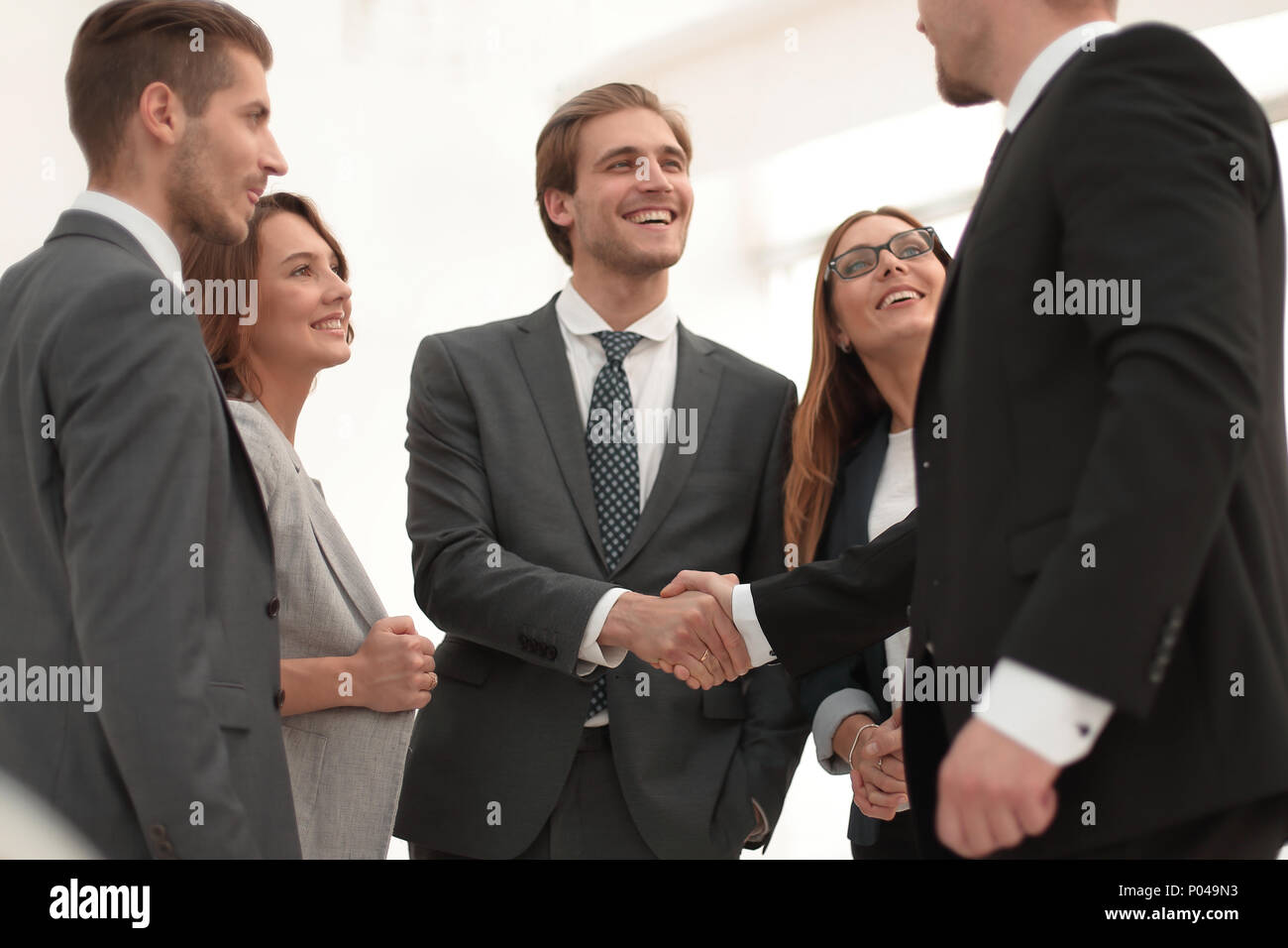 handshake in the lobby of an office building Stock Photo - Alamy