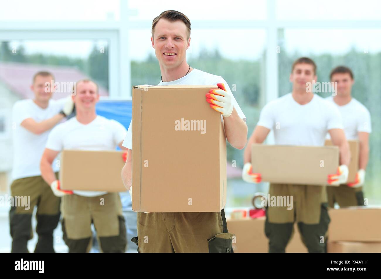 foreman and workers with boxes of building materials Stock Photo - Alamy