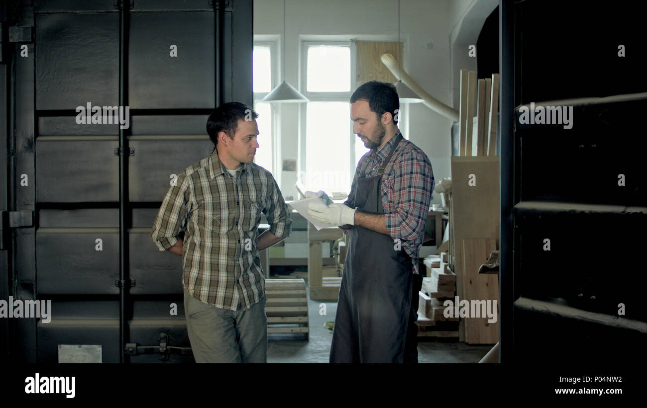 Two men discussing metal hi-res stock photography and images - Alamy