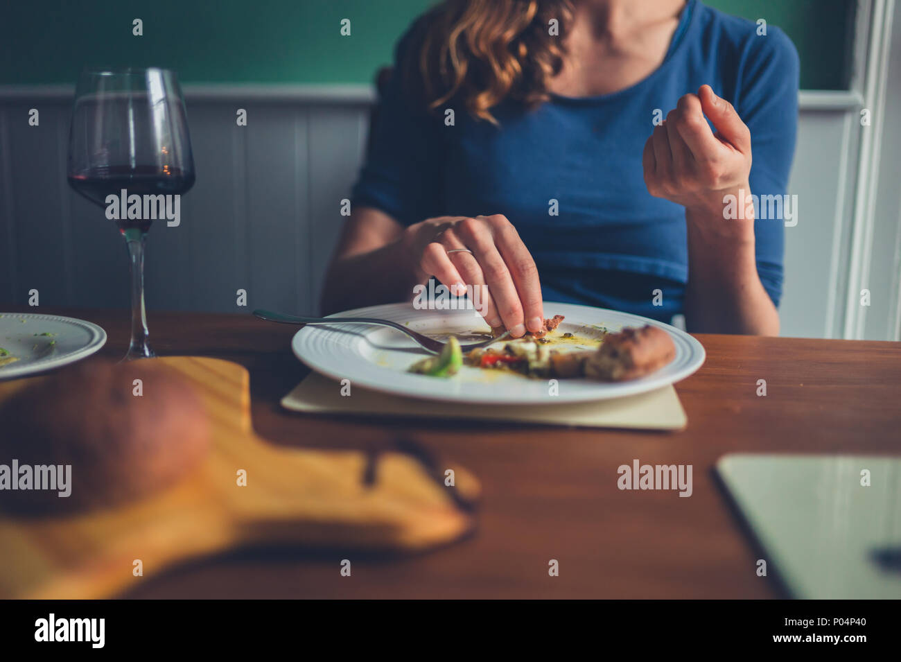 Young woman seated home table hi-res stock photography and images - Alamy
