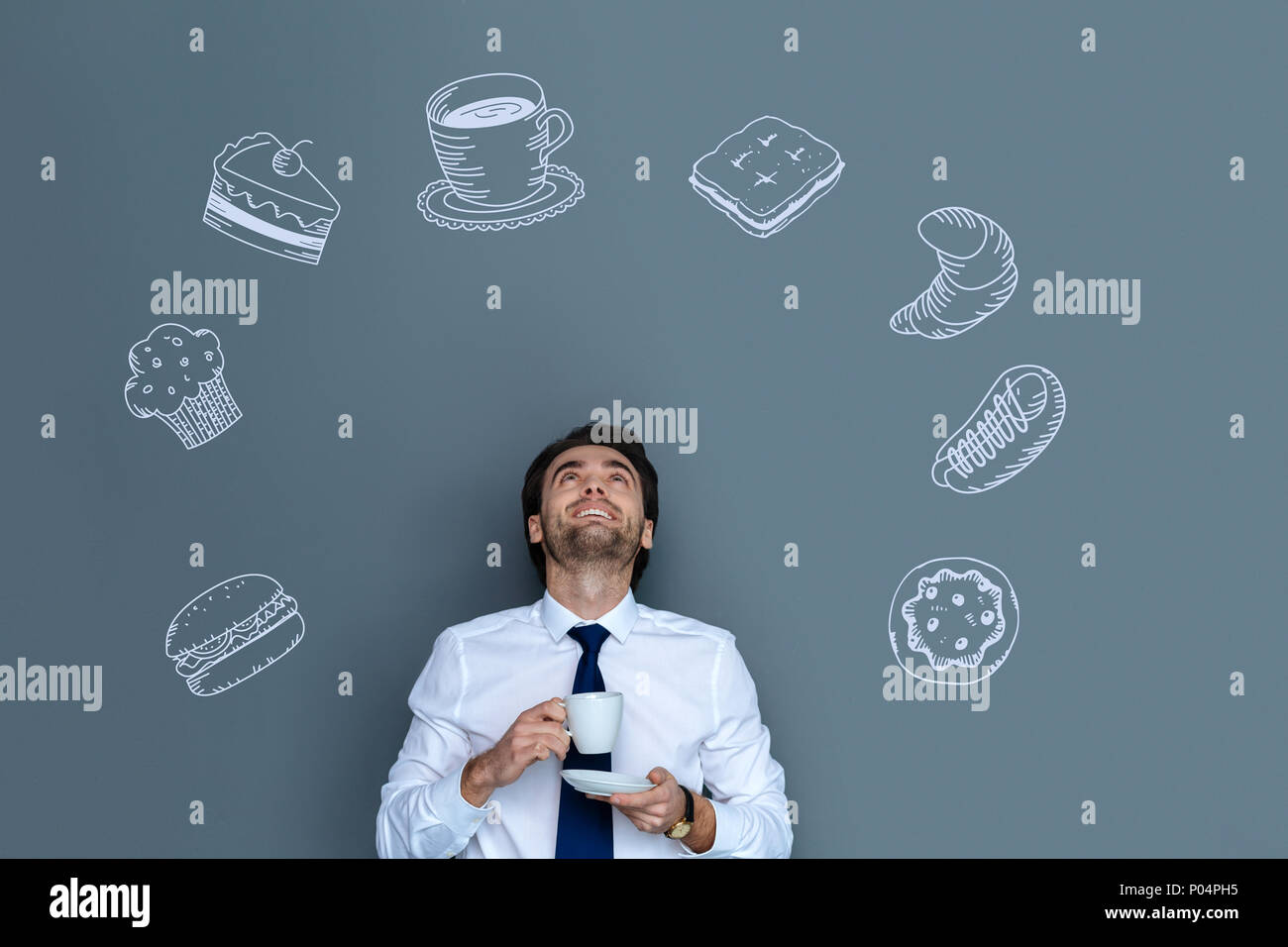 Emotional man drinking coffee and feeling hungry Stock Photo - Alamy