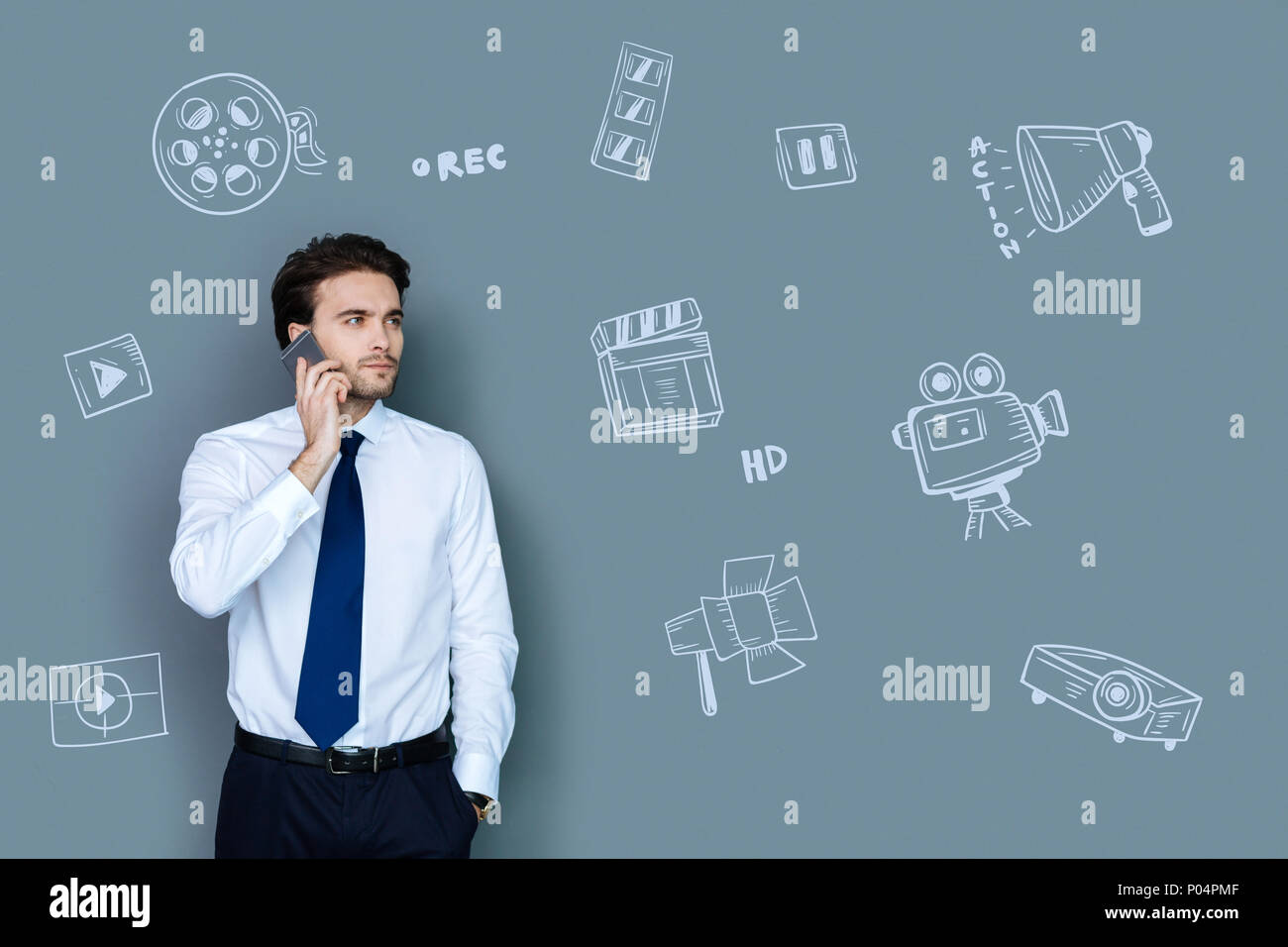 Serious elegant man looking calm while talking on the phone Stock Photo ...