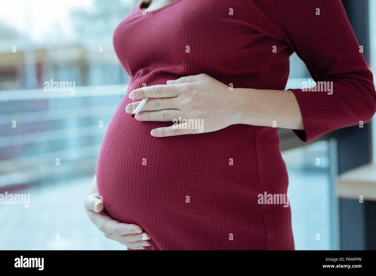 Pregnant businesswoman touching belly hi-res stock photography and ...