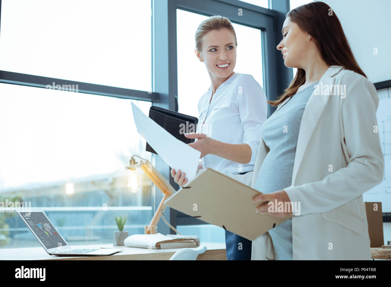 Happy businesswoman giving task to her partner Stock Photo - Alamy