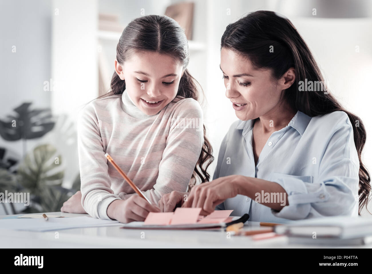 Concentrated child adding information on stickers Stock Photo - Alamy
