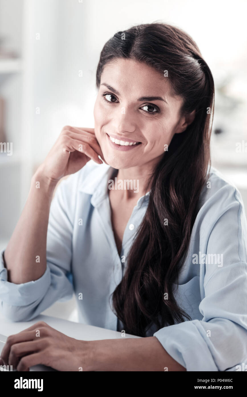 Beautiful brunette demonstrating her tender smile Stock Photo - Alamy