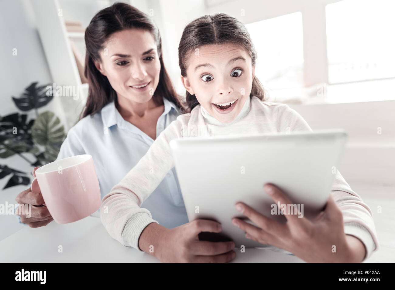 Beautiful brunette girl staring at tablet Stock Photo - Alamy