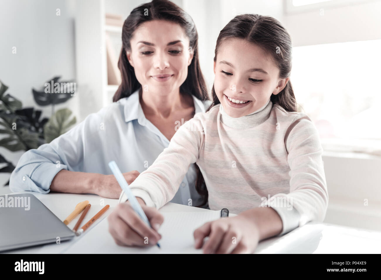 Charming little female drawing picture Stock Photo - Alamy