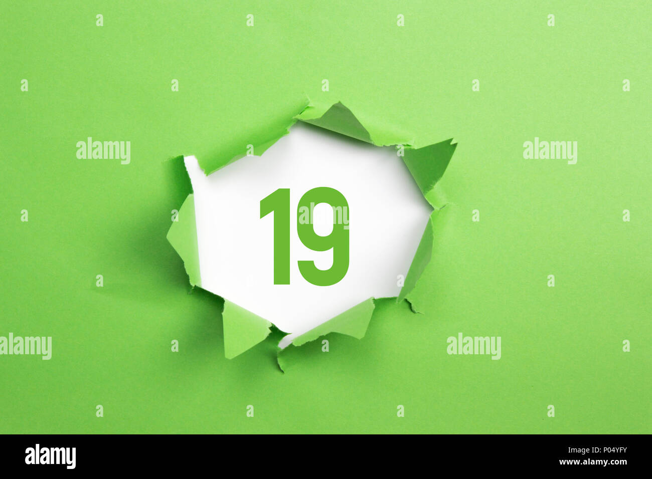 Green Number 75 on green paper background Stock Photo - Alamy