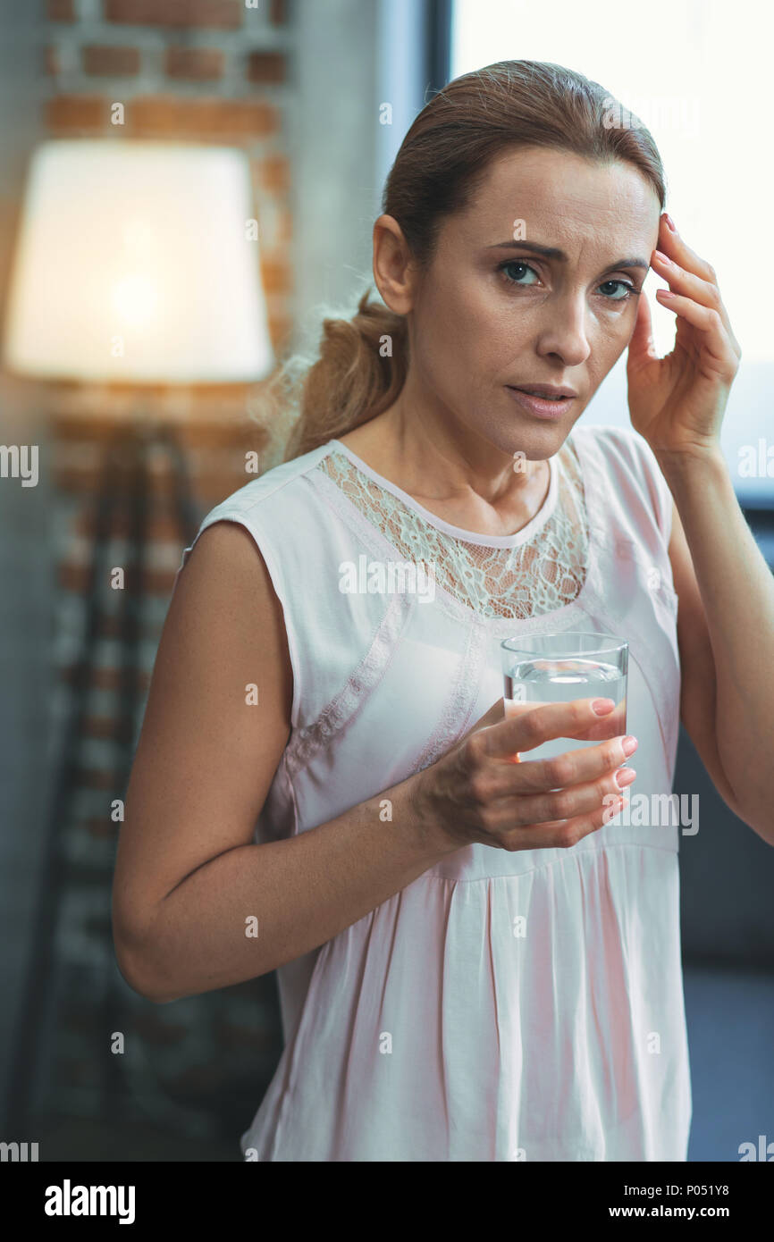 Nice mature woman having headache Stock Photo - Alamy