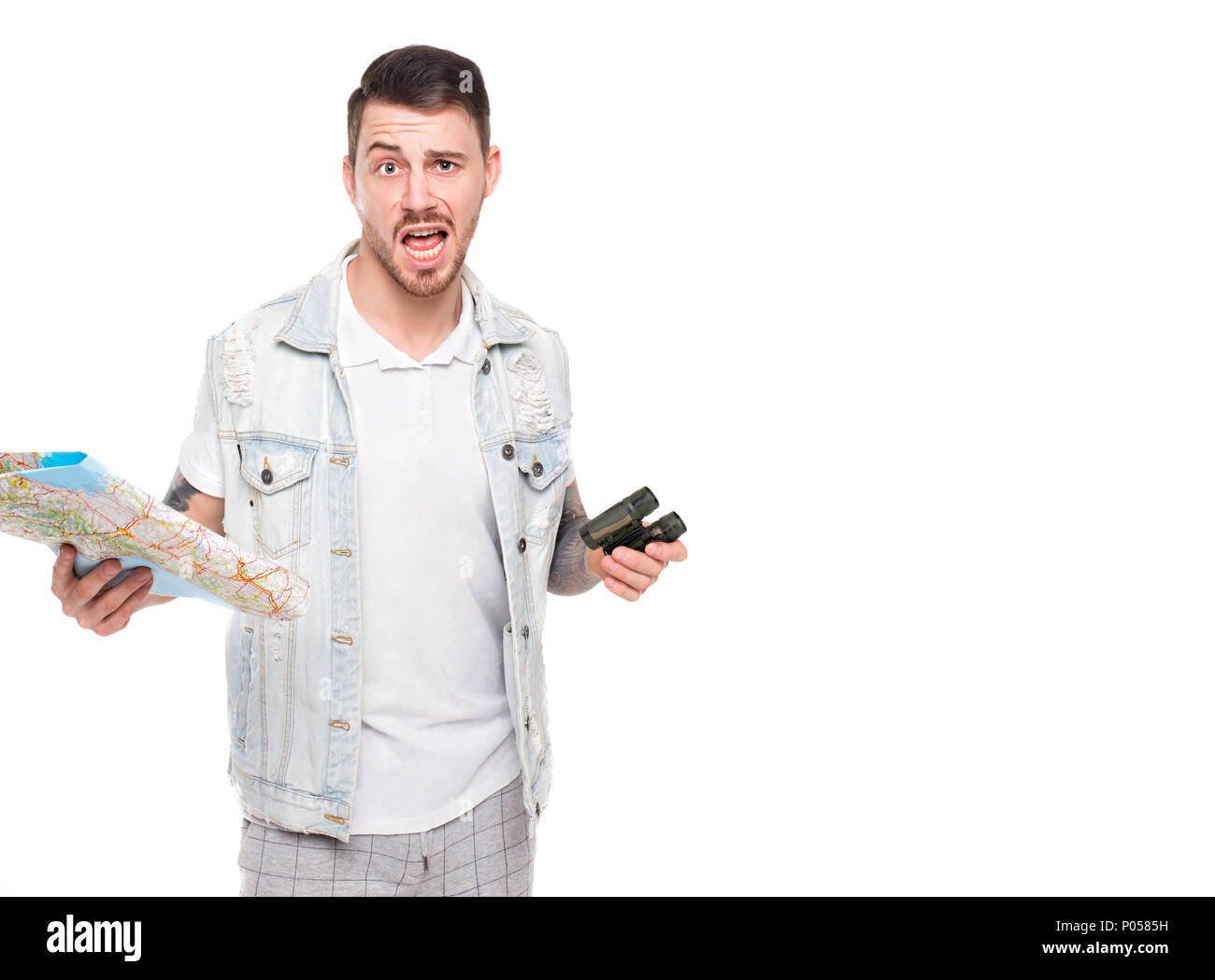 man with a map. Front view. The tourist in the denim jacket is angry or ...