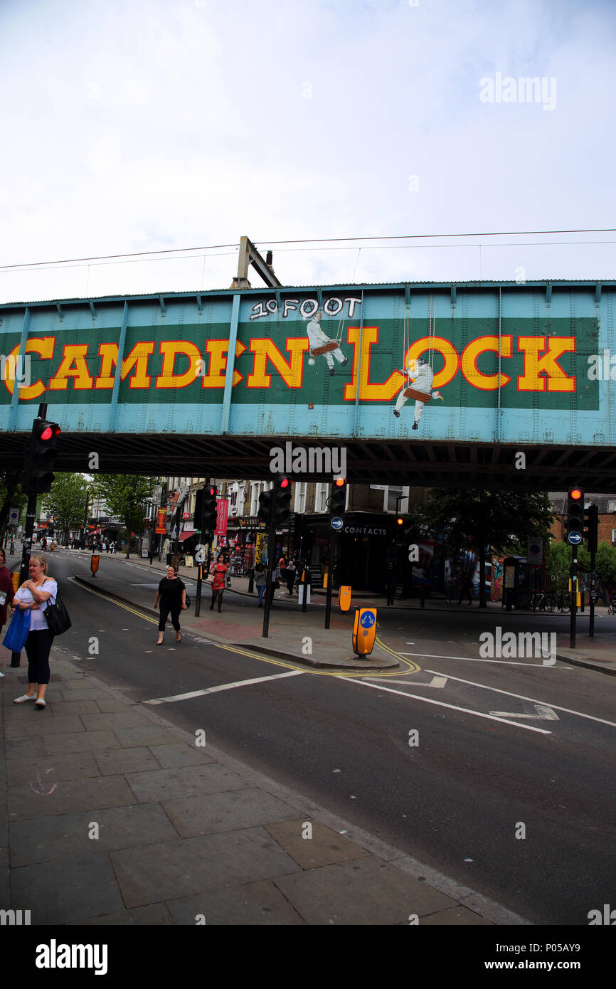 Camden Lock bridge with people walking along the High Street, Camden ...