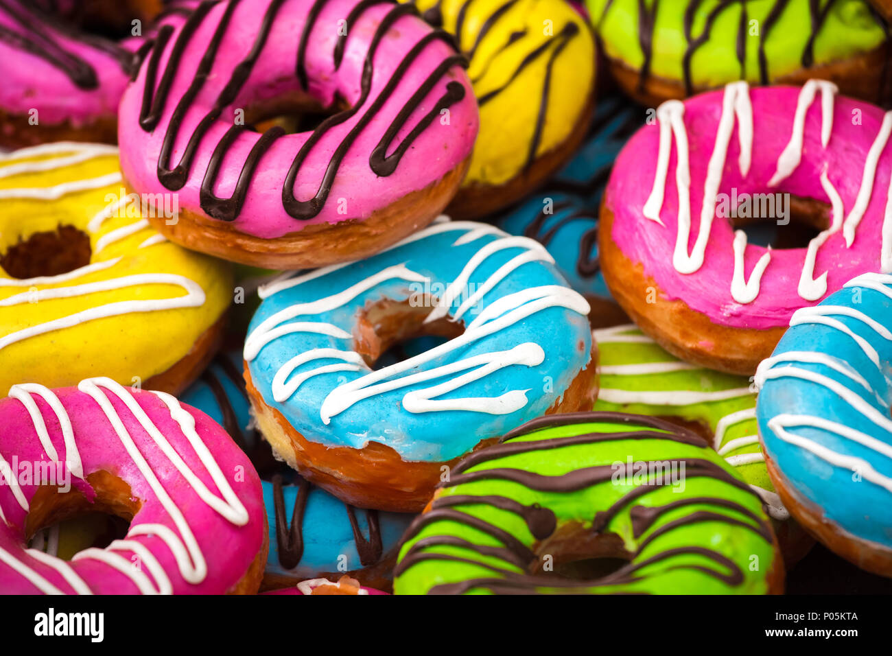 Many colorful donuts, background of different color cakes Stock Photo ...
